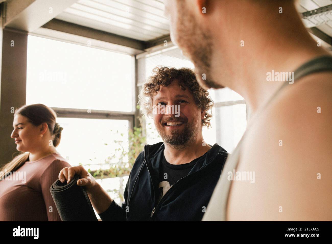 Happy non-binary professional with colleagues in office Stock Photo - Alamy
