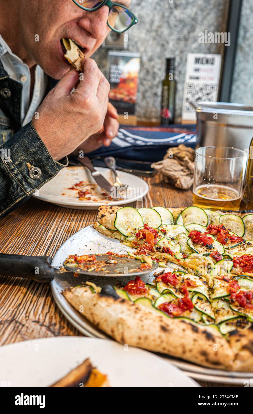 Neapolitan zucchini Pizza on a rustic wooden table in a traditional ...