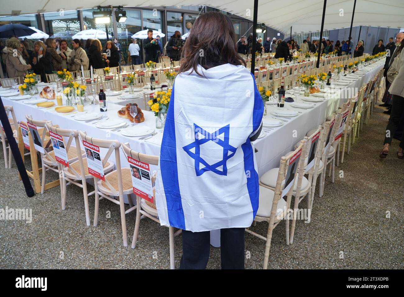 People viewing the Empty Shabbat Table installation, an empty dining ...