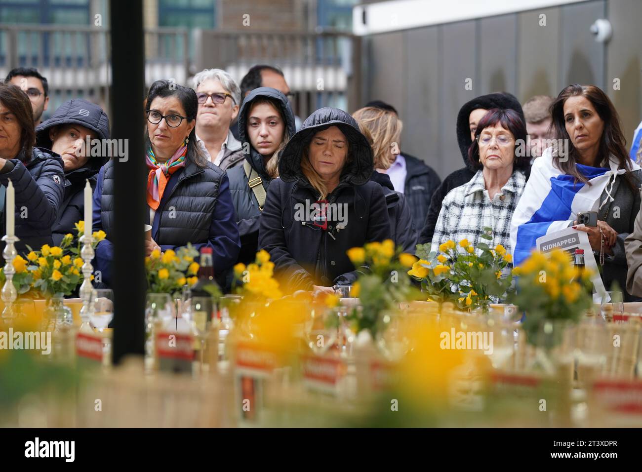 People viewing the Empty Shabbat Table installation, an empty dining ...