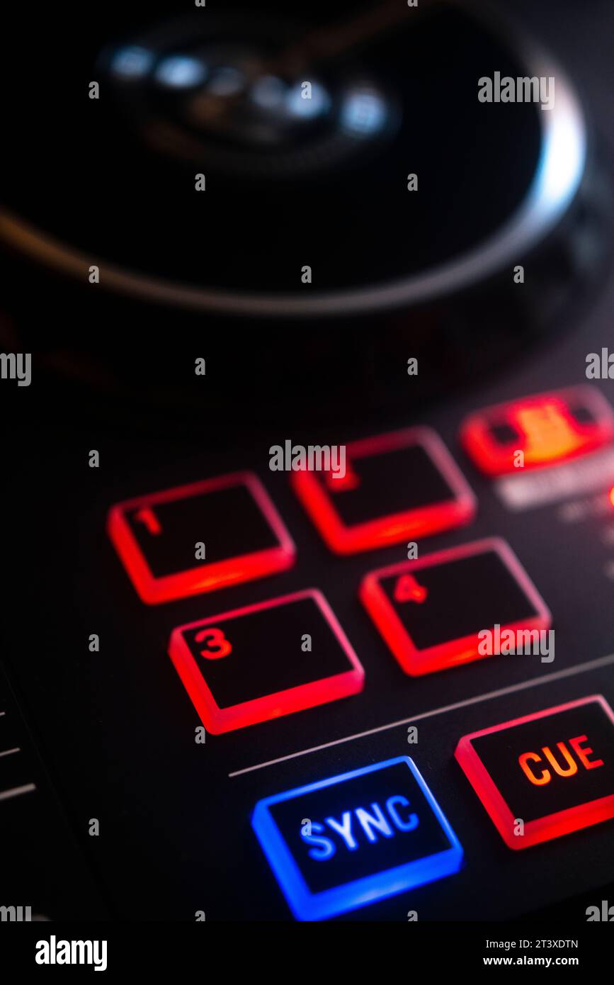 DJ mixing desk turntable in colored wedding disco party lights Stock ...