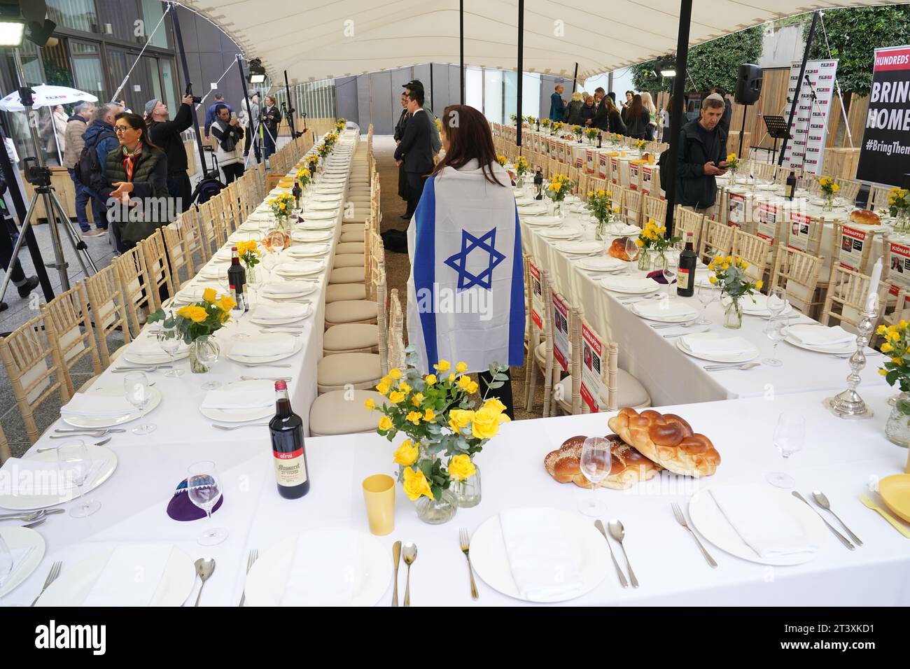 People viewing the Empty Shabbat Table installation, an empty dining ...