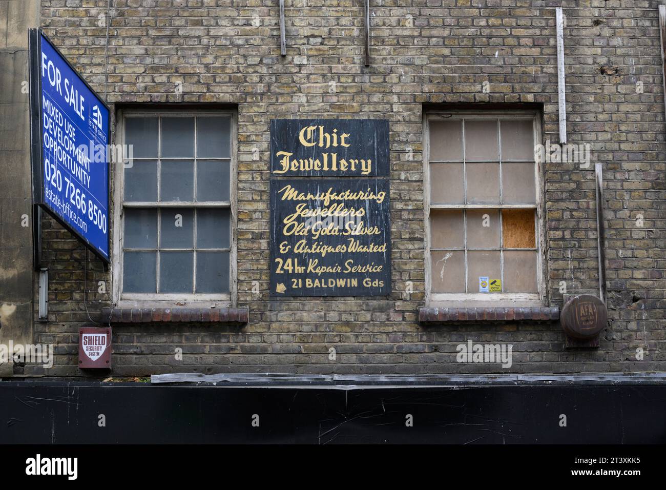 An old jewellery shop sign on a building for sale, Leather Lane, Hatton ...