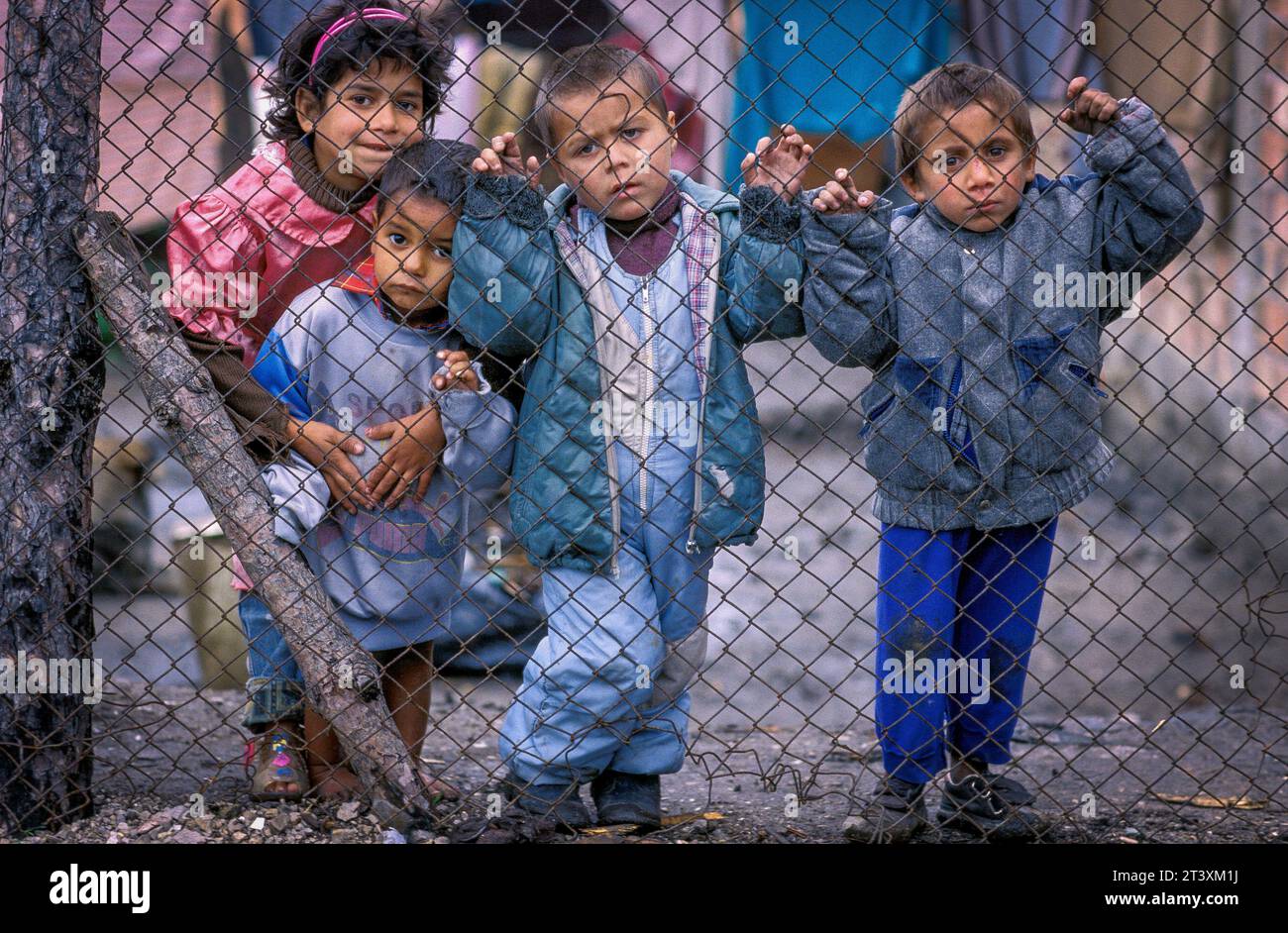 Bulgaria, Sofia . Roma children behind the fence of their living ...