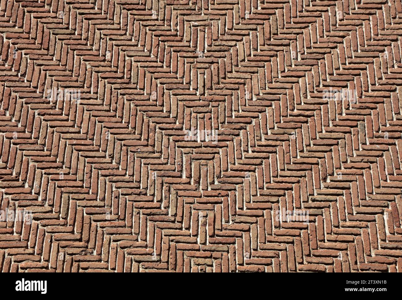 A wall with geometric motifs. Detail of a wall made of brick. Brown ...