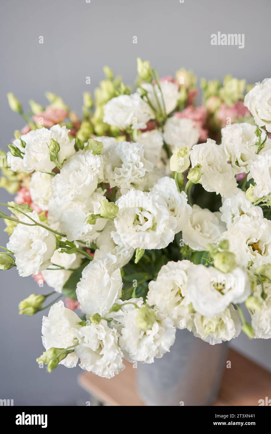 Bunches of flowers white eustoma in vases. Lovely Vintage background ...