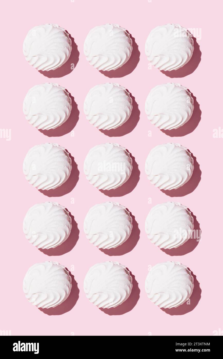 White zephyr pattern on light pink table background in hard light ...