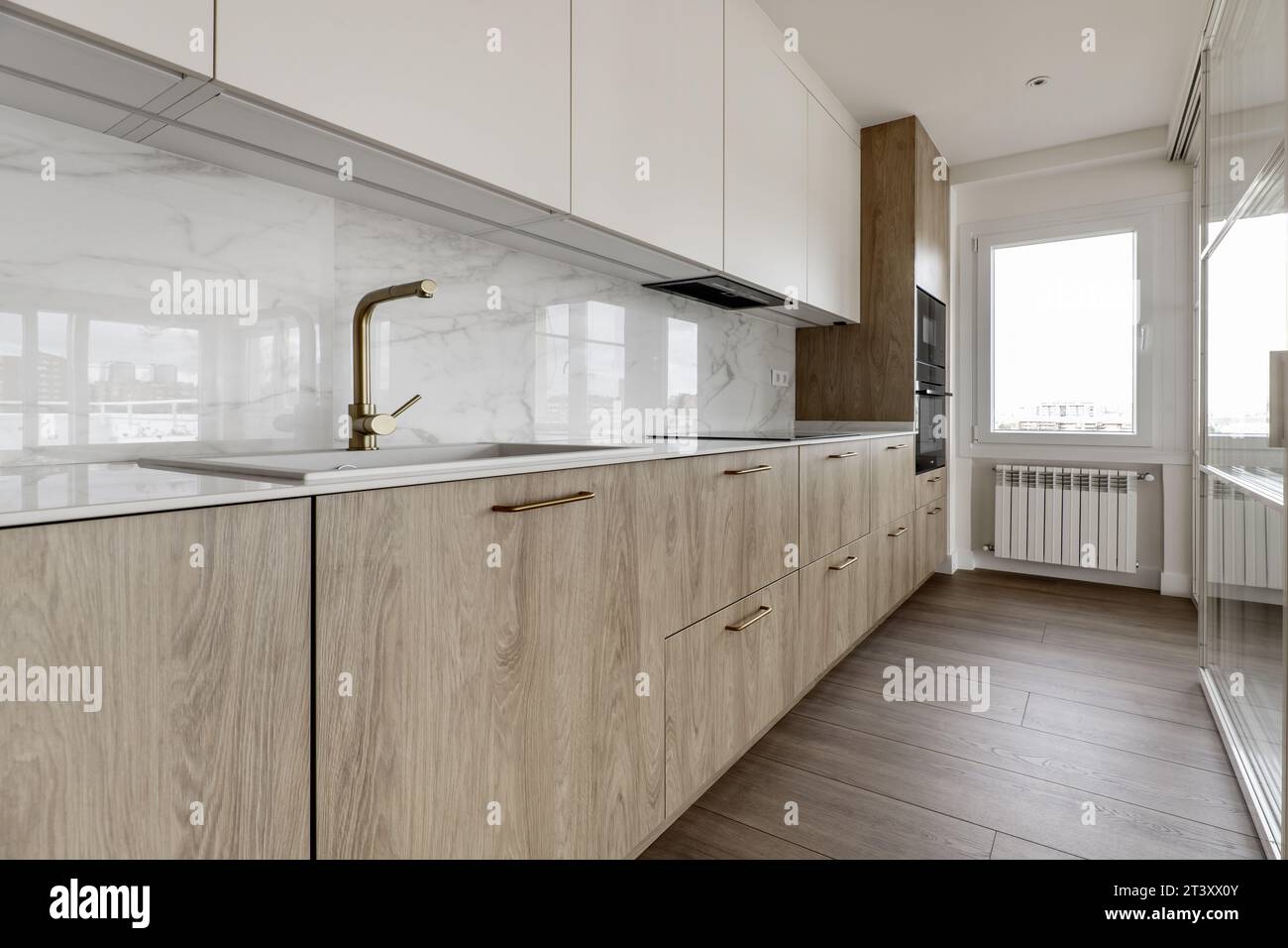 Modern open kitchen with white metal and glass retractable screen, gold ...