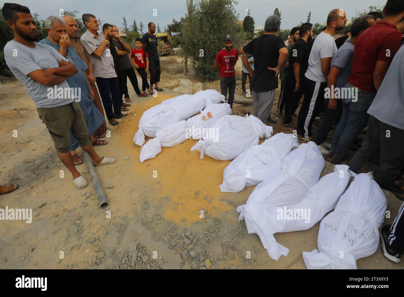 Al-Zawayda, Gaza. October 27, 2023. People bury bodies of killed ...