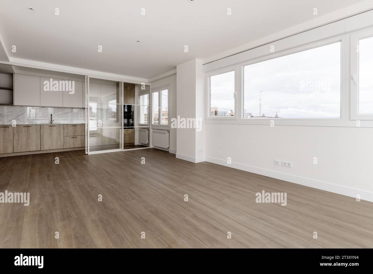 Empty living room with large windows Stock Photo - Alamy