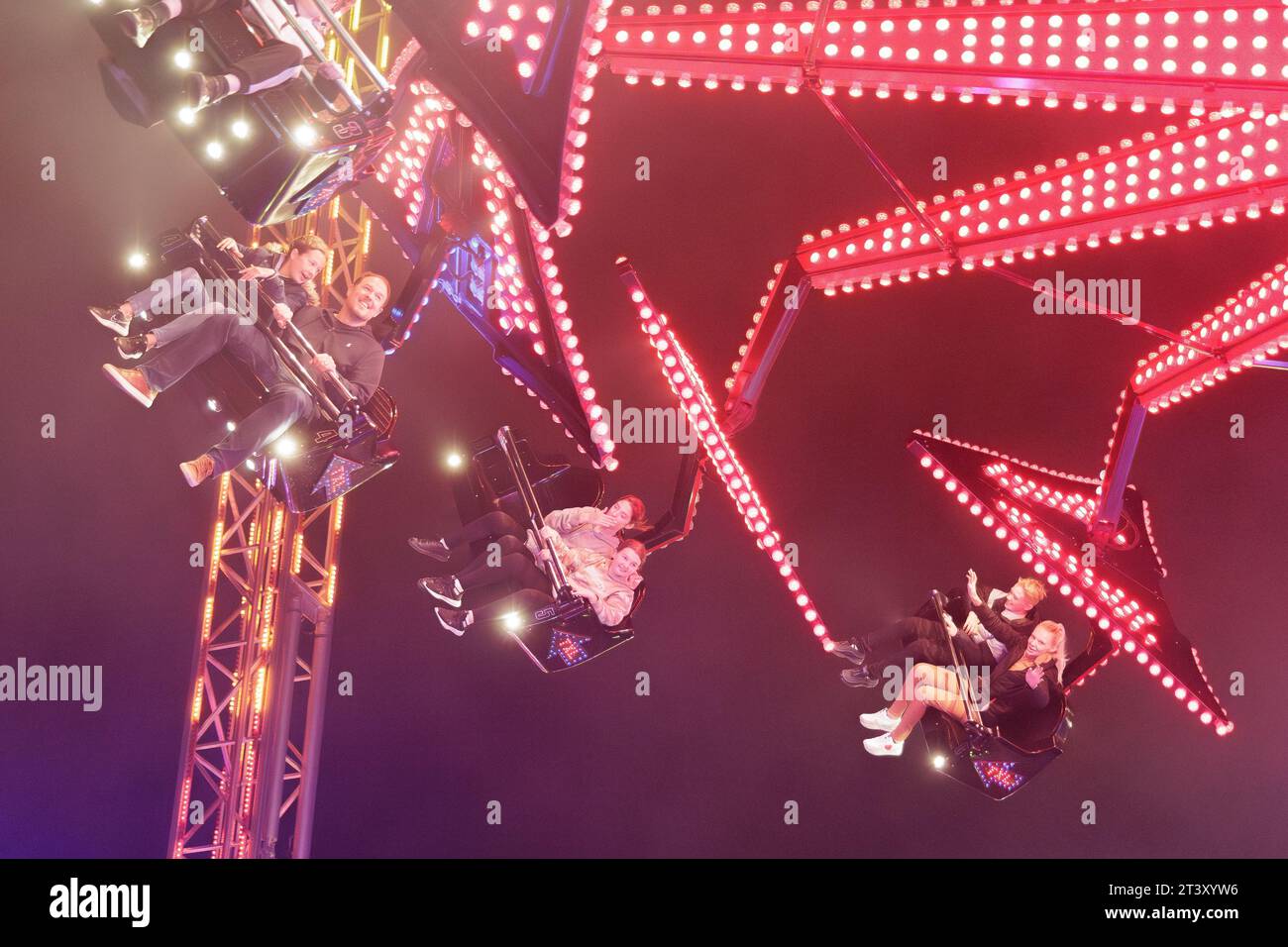 People enjoying a fairground ride at night, the Stratford upon Avon Mop ...