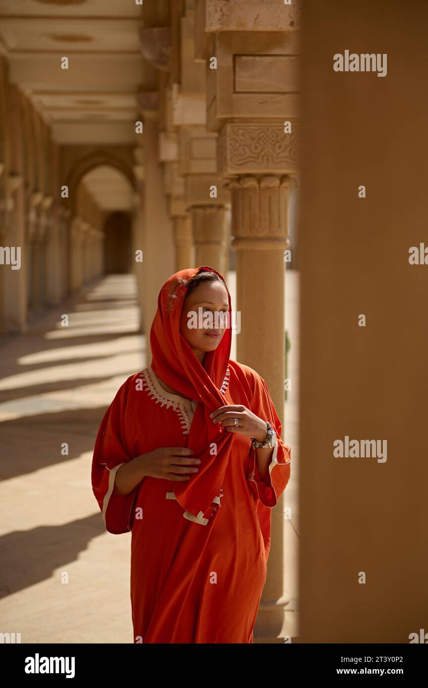 Beautiful Middle Eastern Muslim woman with head covered in hijab, walks ...