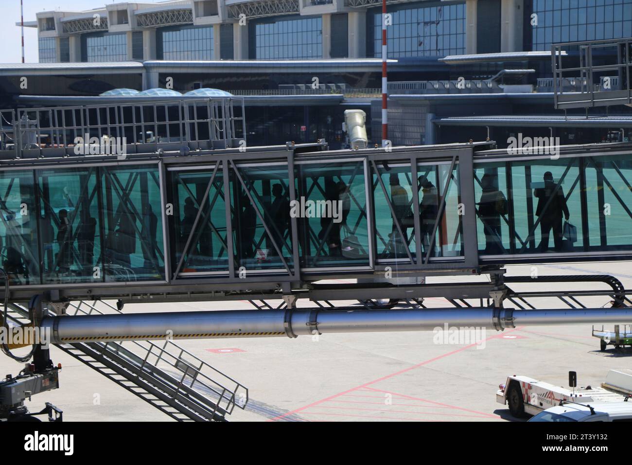 Travelers use a jet bridge for boarding on aircraft Stock Photo - Alamy