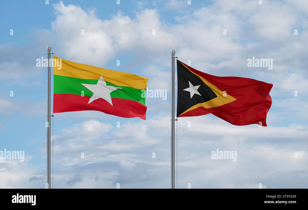 East Timor and Myanmar flags waving together in the wind on blue cloudy ...