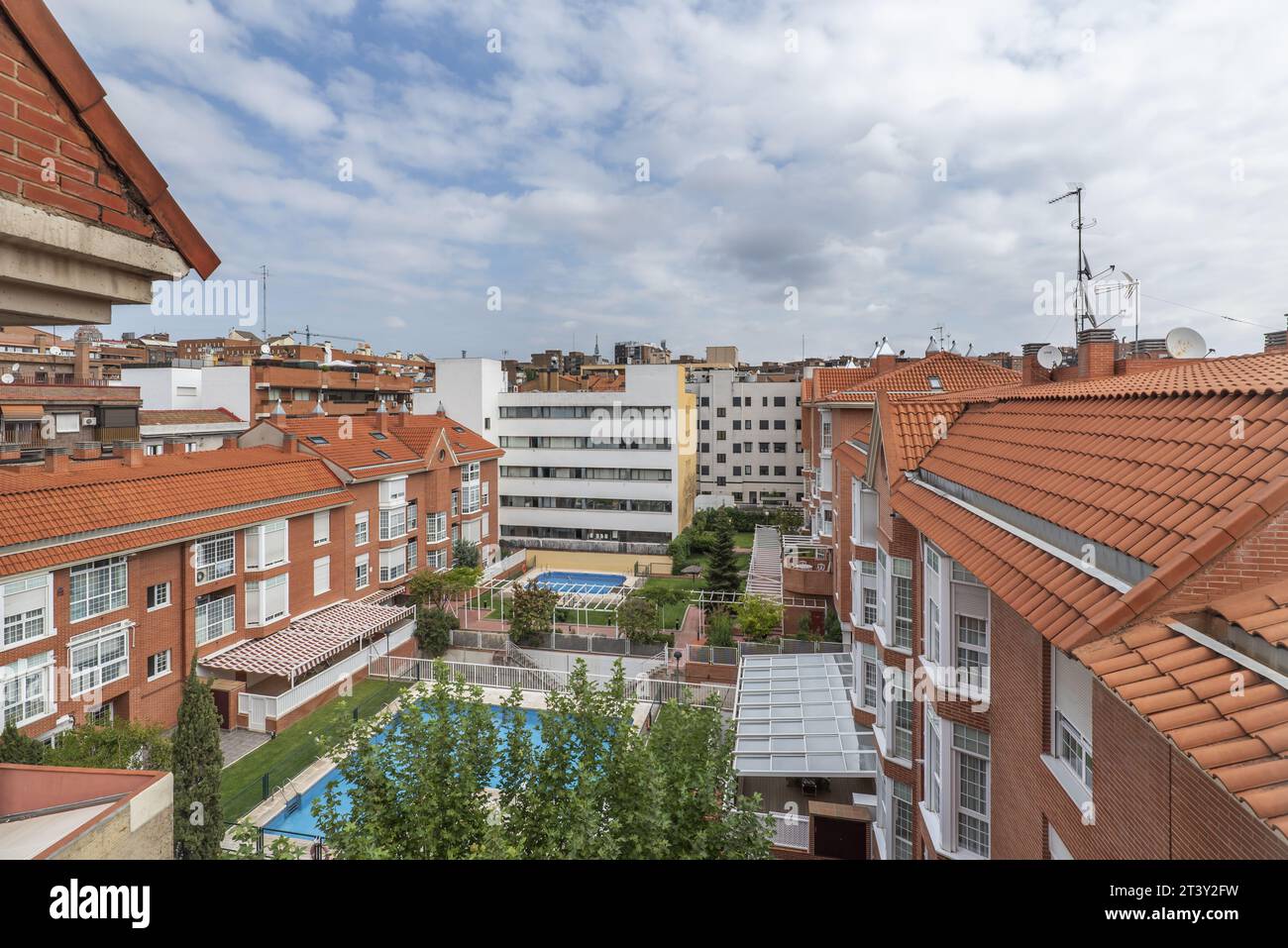 Panoramic image of an open block patio between facades and roofs of ...