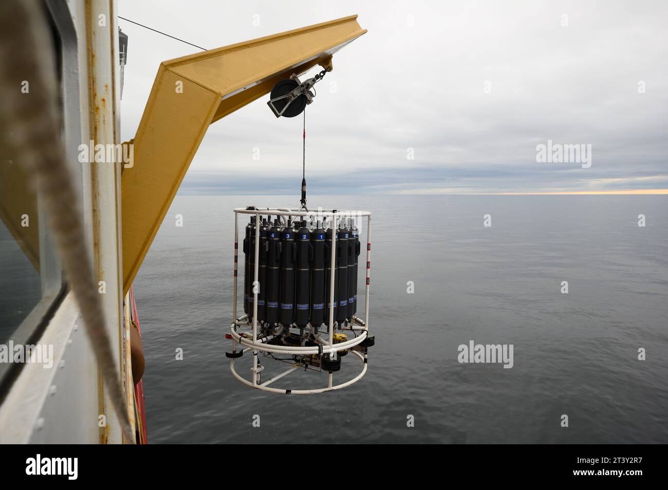 A scientific instrument called a rosette is pulled from the waters of ...