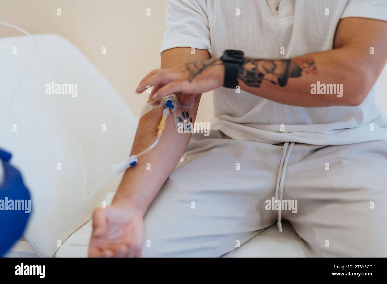 Doctor checking lab reports, giving infusion to patient in hospital ...