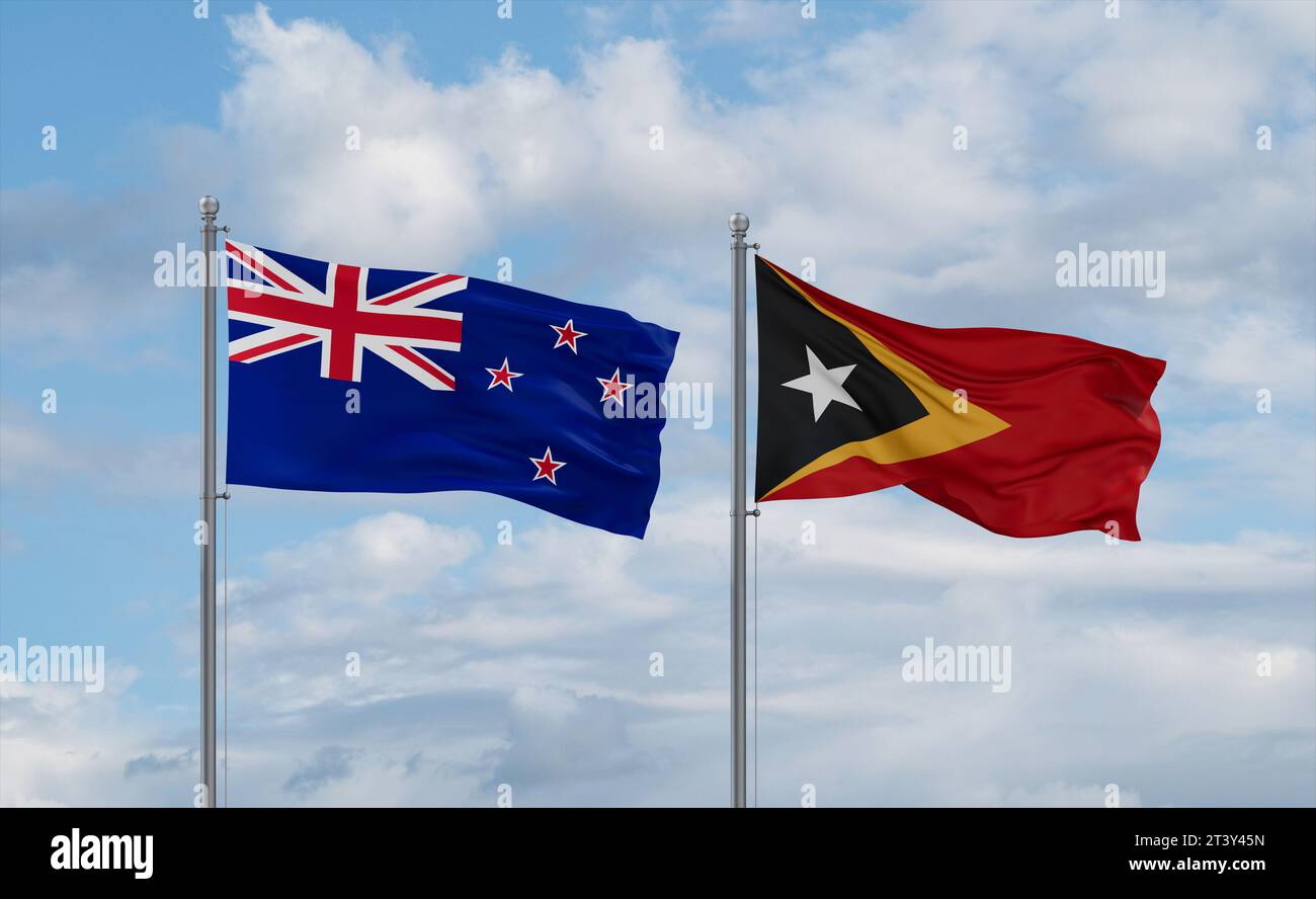 East Timor and New Zealand flags waving together in the wind on blue ...