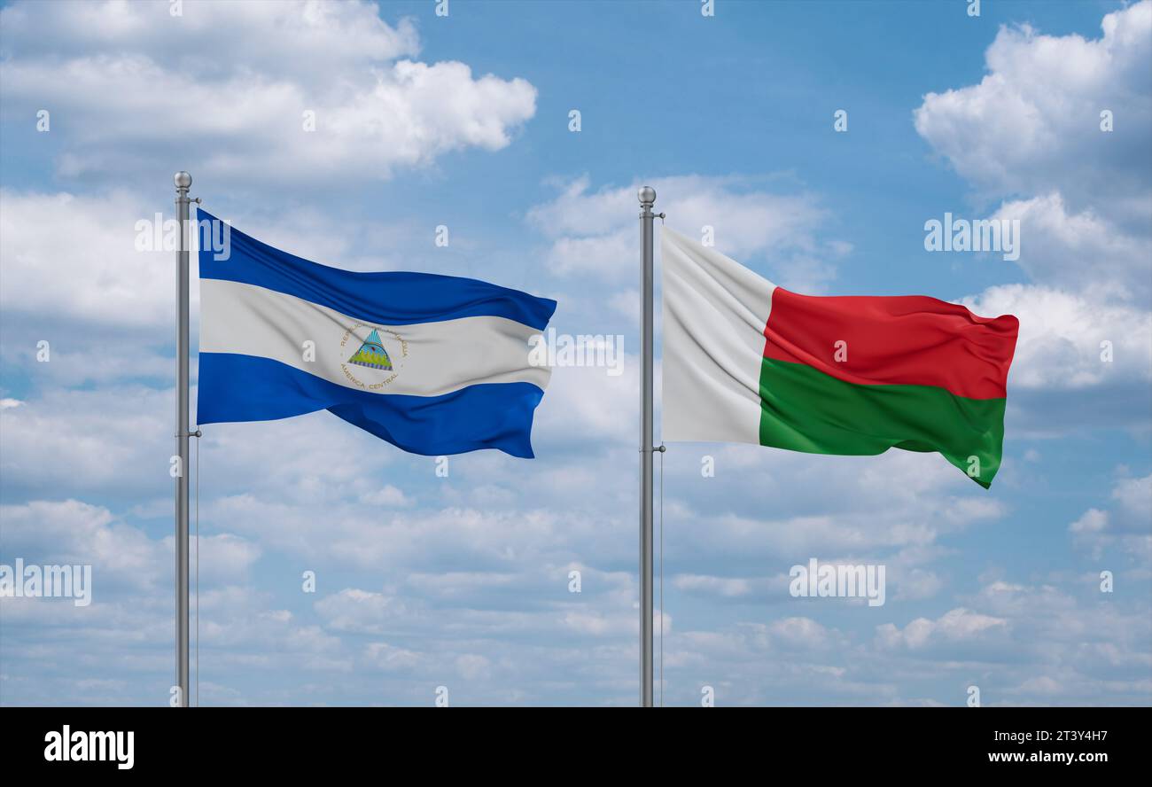 Madagascar and Nicaragua flags waving together on blue cloudy sky, two country relationship ...
