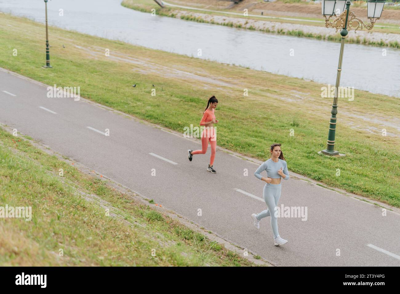 Athletes transforming bodies, doing cardio in the city. Fit girls in ...