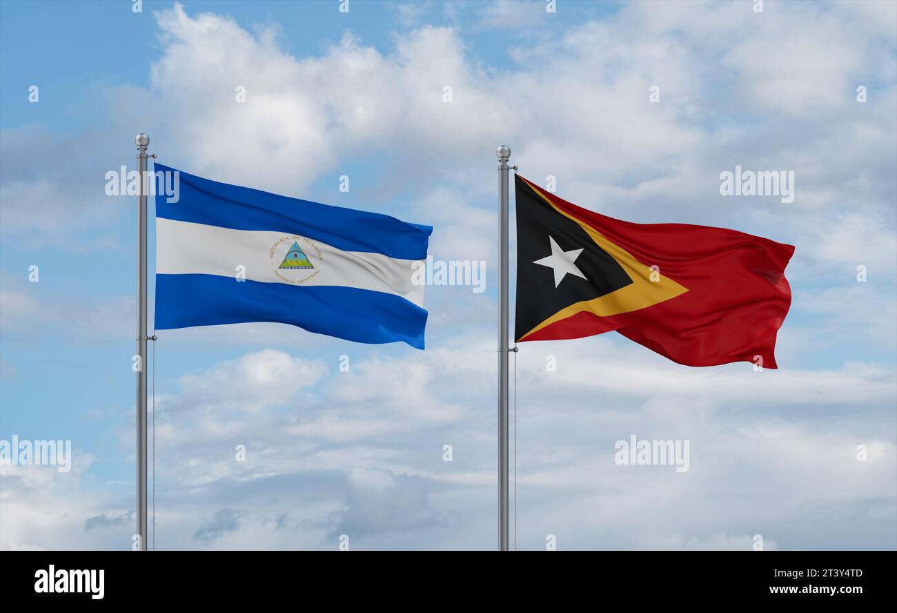 East Timor and Nicaragua flags waving together in the wind on blue cloudy sky, two country ...