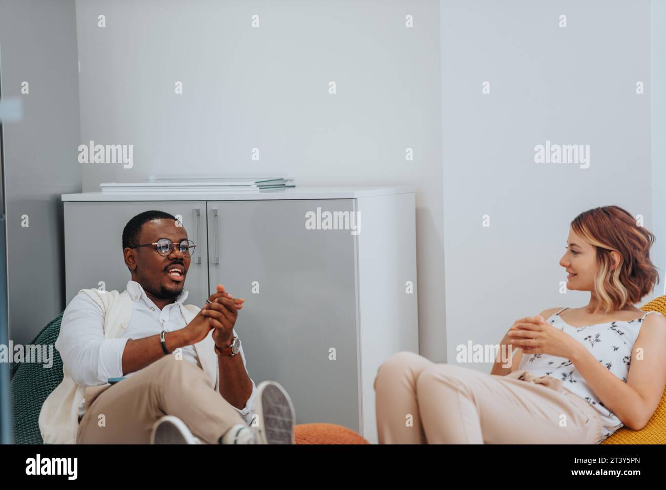 Break at work concept. Employees rest, recharge, and discuss, enjoying a positive atmosphere in ...