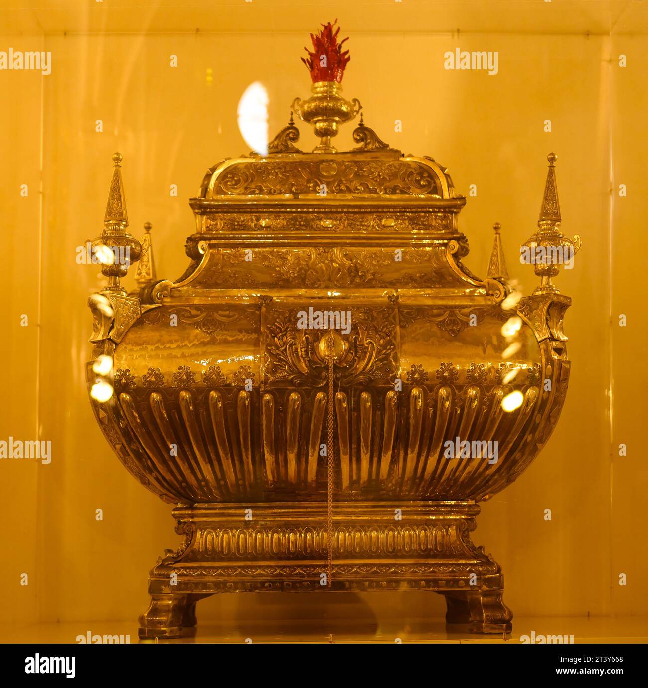 Murcia Cathedral, Spain. Gold-colored metallic urn behind a glass. The ...