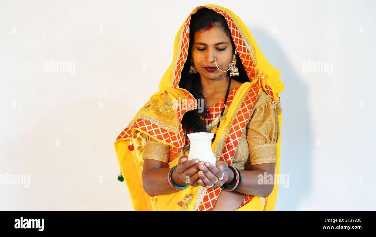 Indian young woman wearing traditional costume and holding karwa or ...