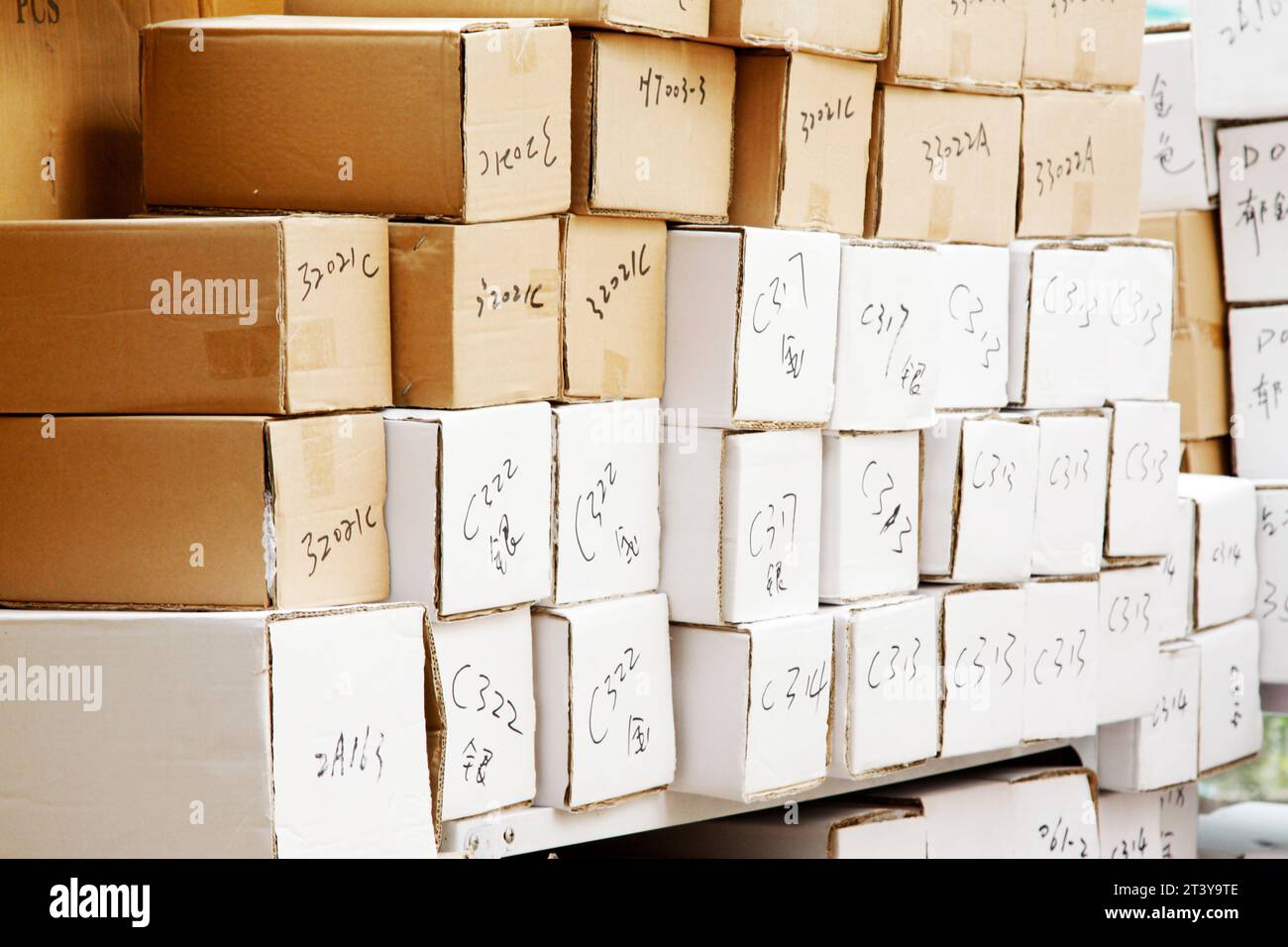 goods paper boxes piled up together in a shop Stock Photo - Alamy