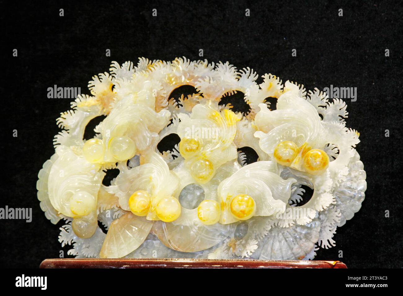 Jade carvings goldfish on a black background Stock Photo - Alamy