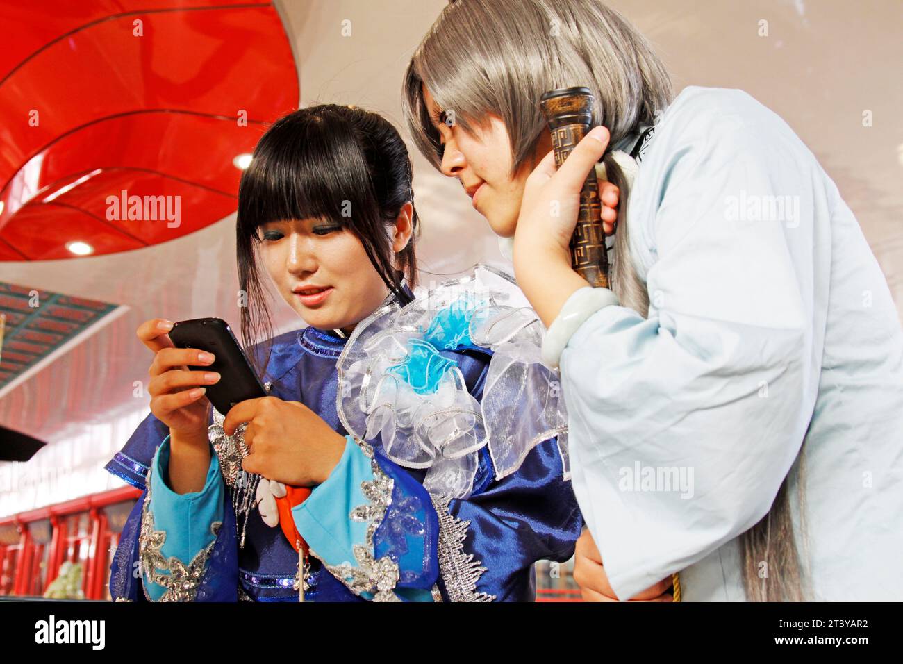 TANGSHAN - OCOTOBER 7: A girl checking phone, dressed in traditional ...