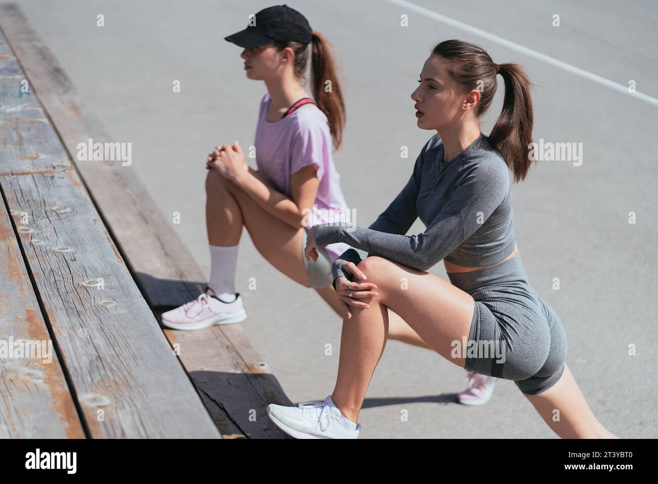 Sportsgirls stretching their legs Stock Photo - Alamy