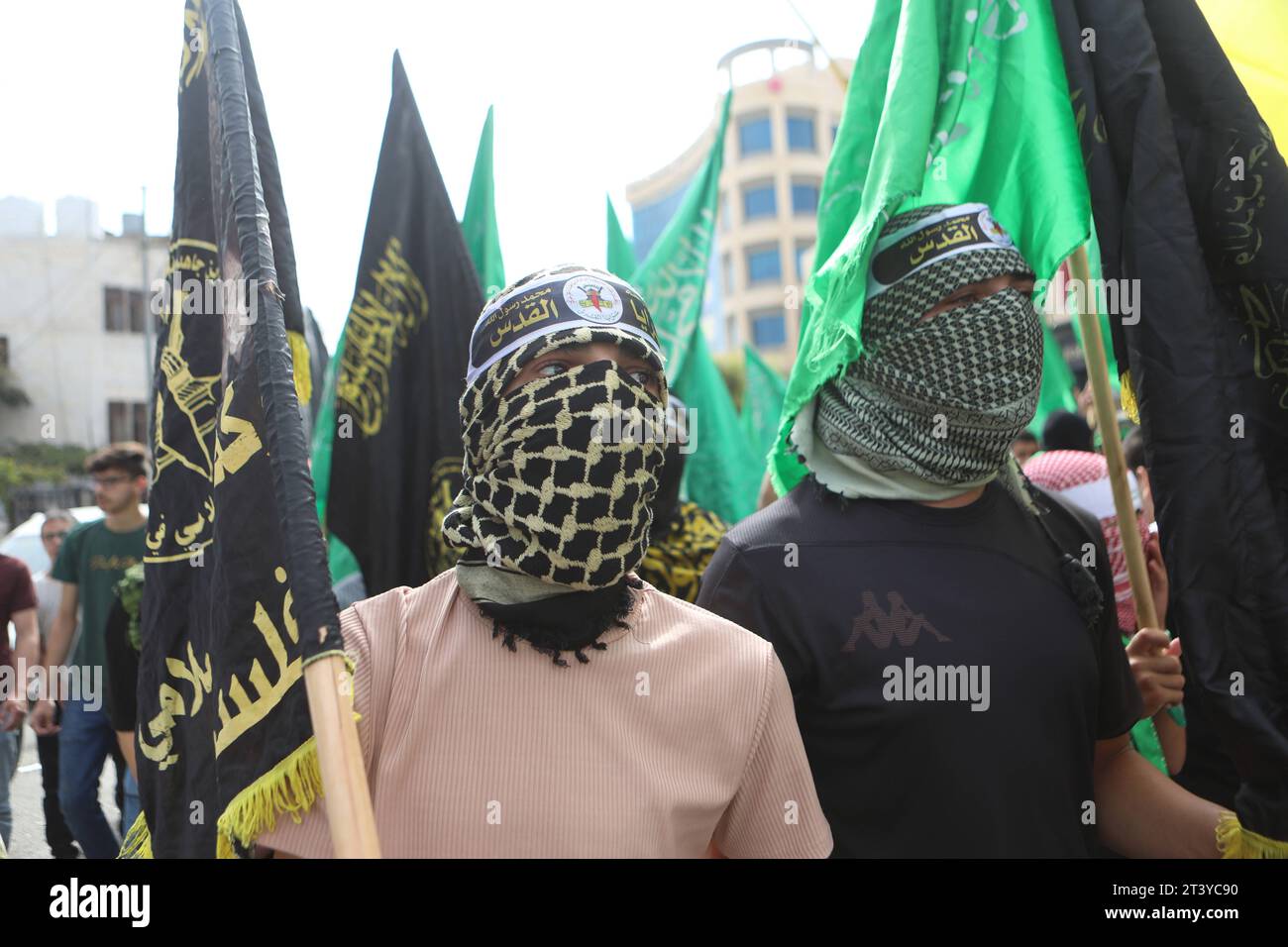 Palestinians waves Hamas and Fateh flags as they takes part in a march ...