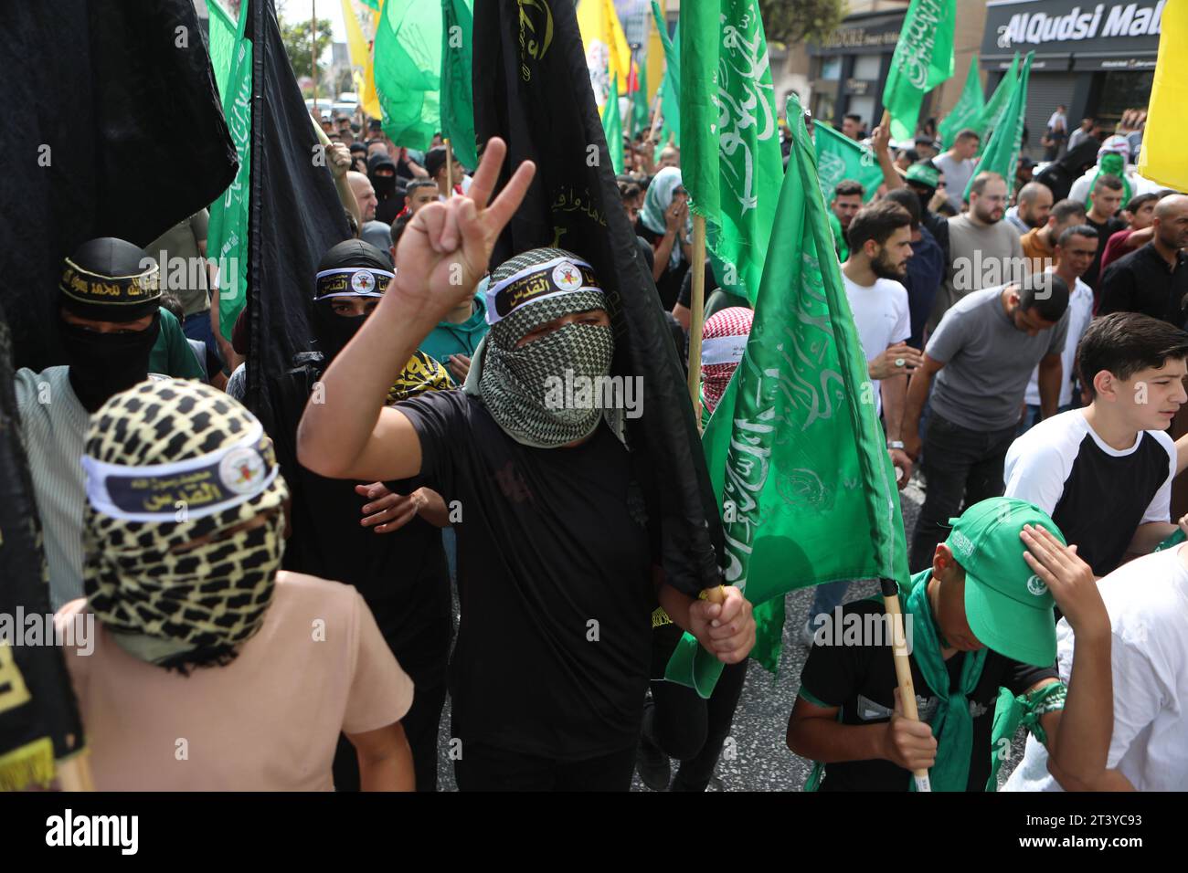 Palestinians waves Hamas and Fateh flags as they takes part in a march ...