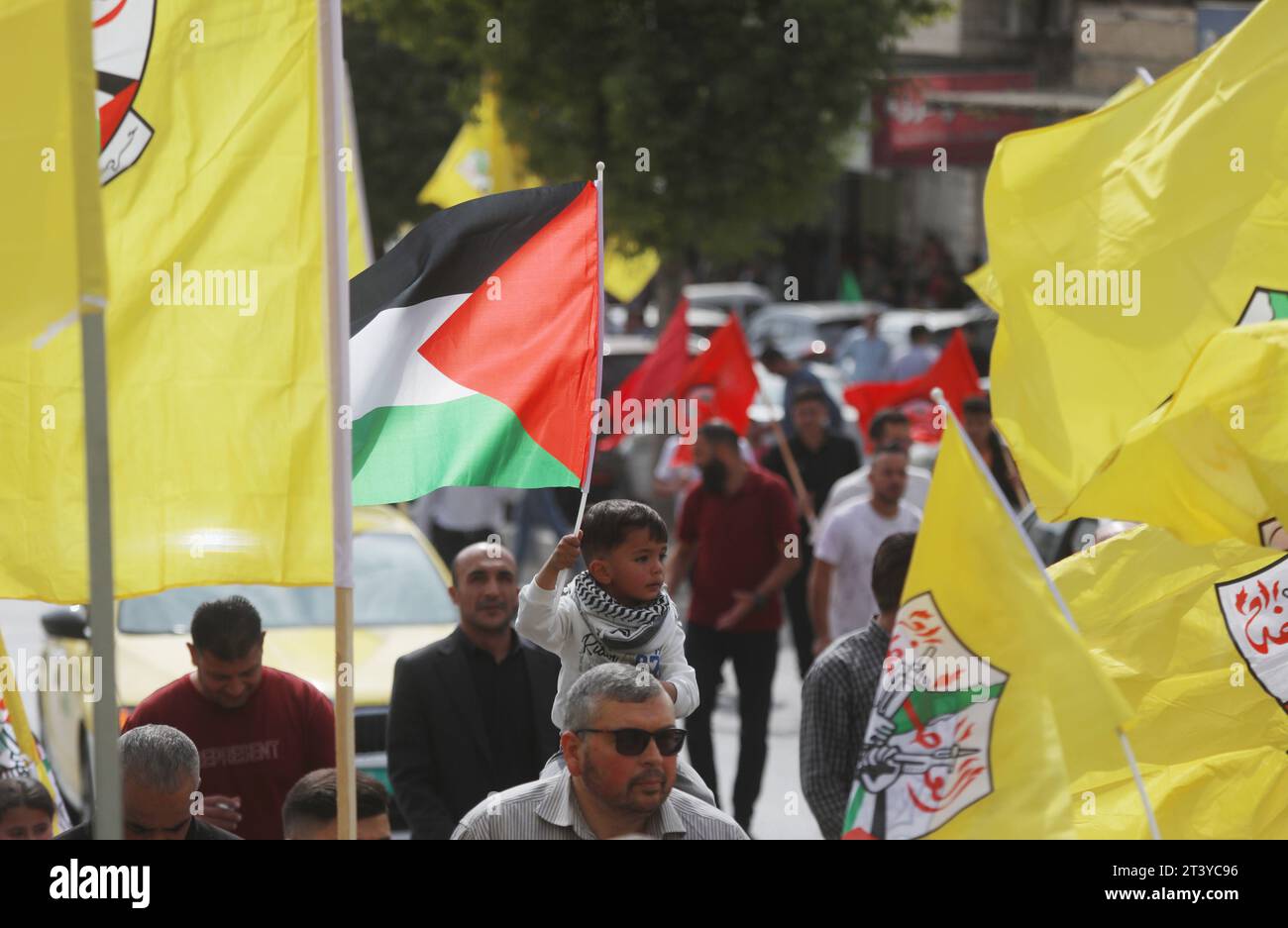 Palestinians waves Hamas and Fateh flags as they takes part in a march ...