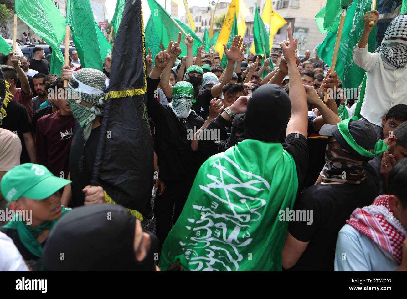 Palestinians waves Hamas and Fateh flags as they takes part in a march ...