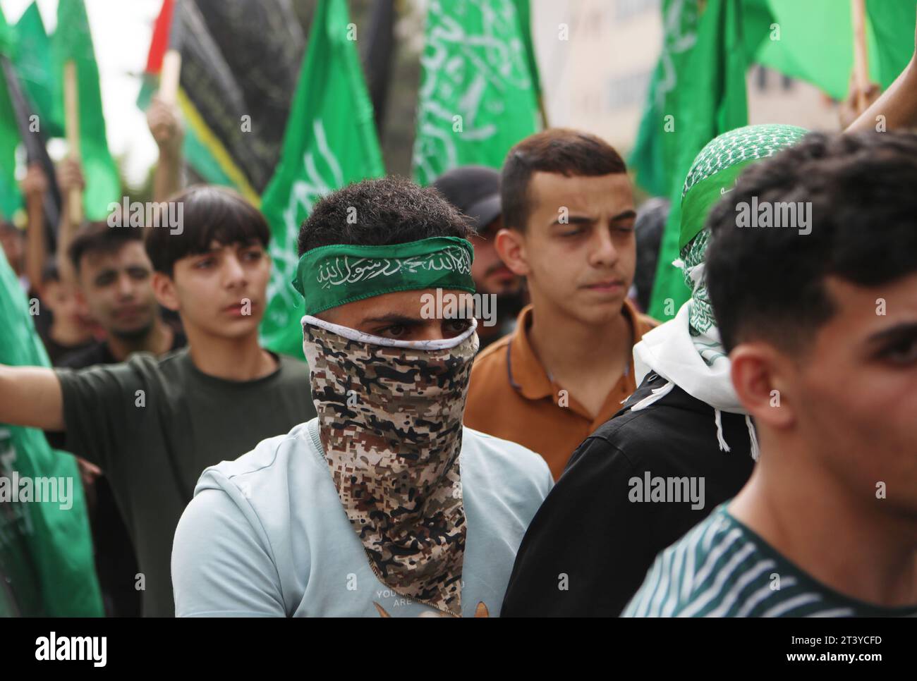 Palestinians waves Hamas and Fateh flags as they takes part in a march ...