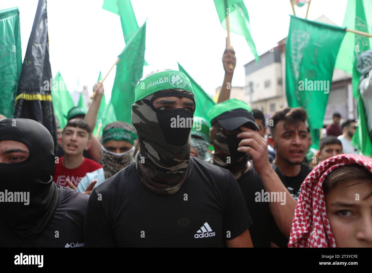 Palestinians waves Hamas and Fateh flags as they takes part in a march ...