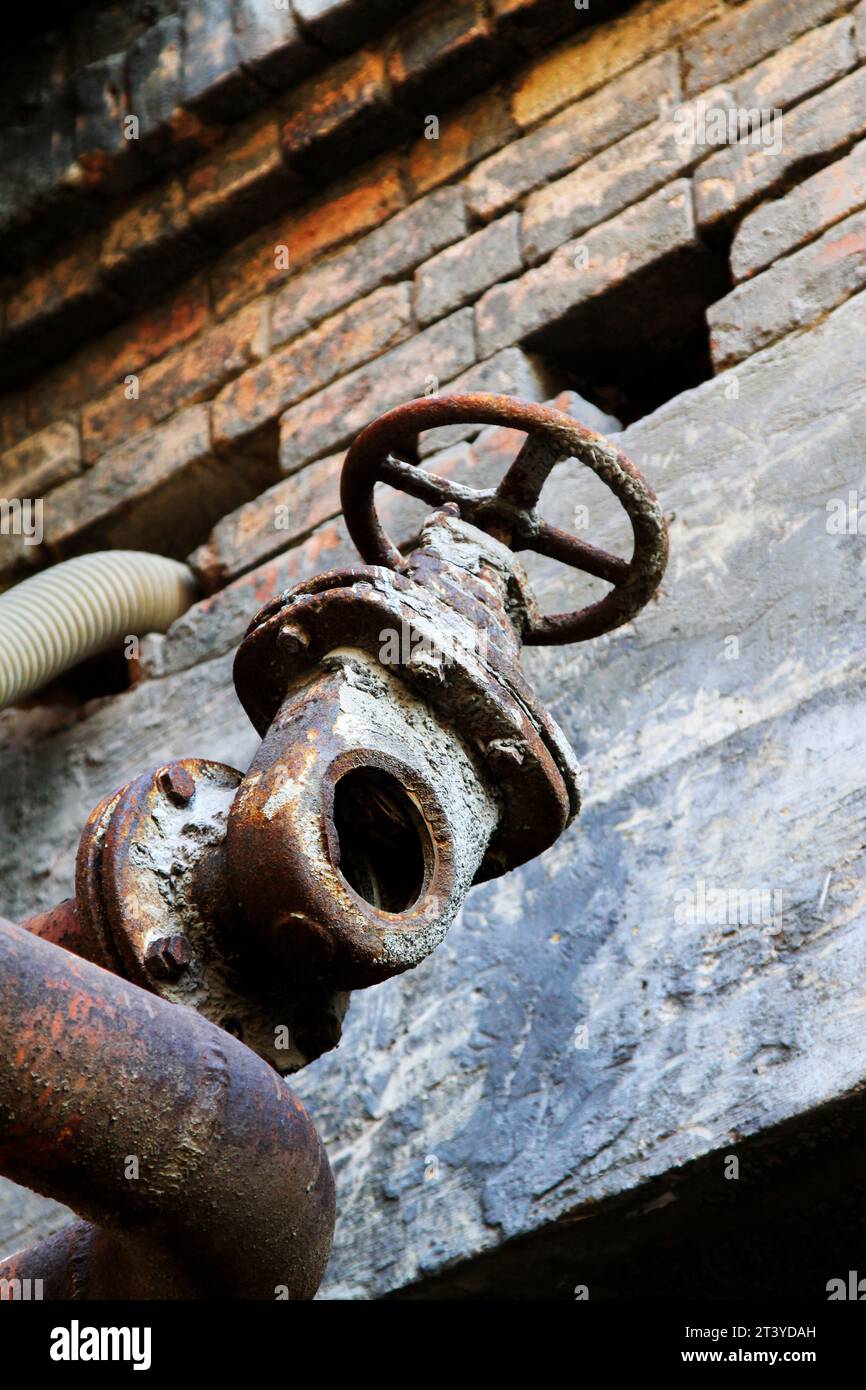 abandoned dirty pipe valve in a factory Stock Photo - Alamy