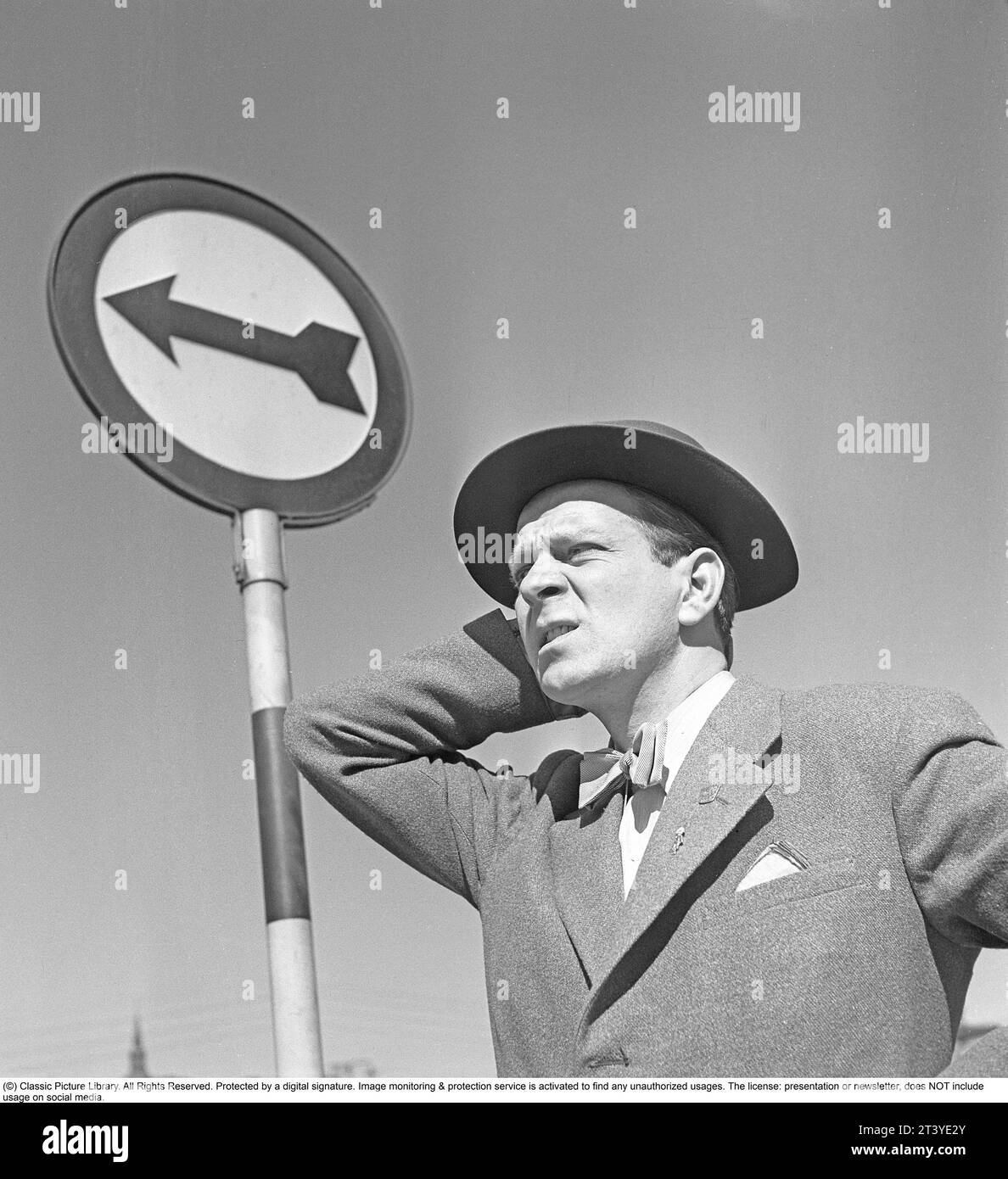 Wondering which way to go? A man stands scratching the back of his head ...