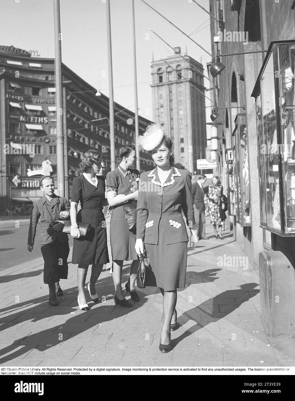 Woman in the 1940s. Actress Barbro Kollberg walking along the busy ...