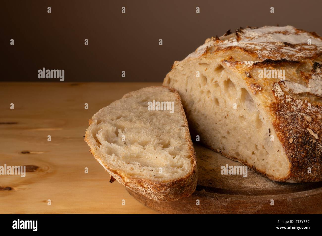 Healthy and very crunchy sourdough bread resting on a board Stock Photo ...