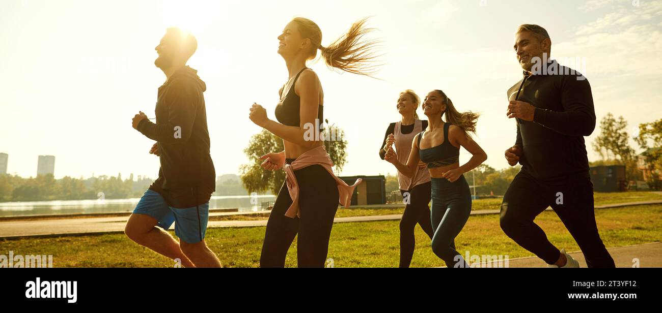 Group of happy diverse athletes having running workout on sunny city ...
