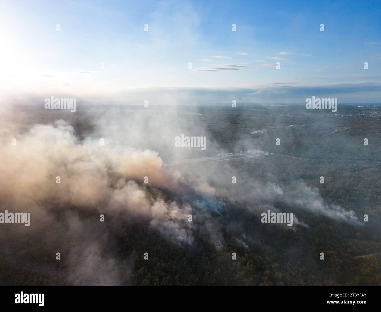 Aerial view of smoke from wildfire in the fields during drought and hot ...