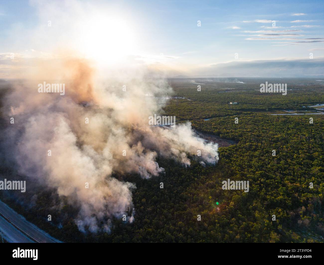 Aerial view the sun shines through the yellow smoke from wildfire in ...