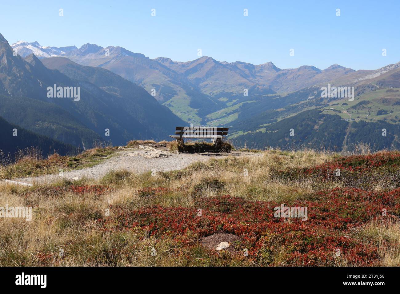 wide-angle shot of a wooden bench in the mountains with panoramic view ...