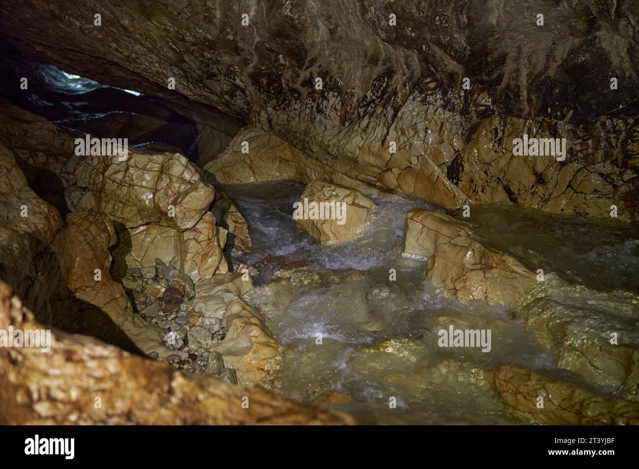 Underground river flowing through a cave in limestone mountains Stock ...