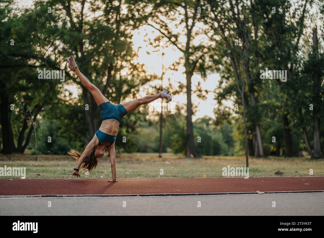 Flexibility and Strength in Nature: Girl Show Off Athletic Skills with ...