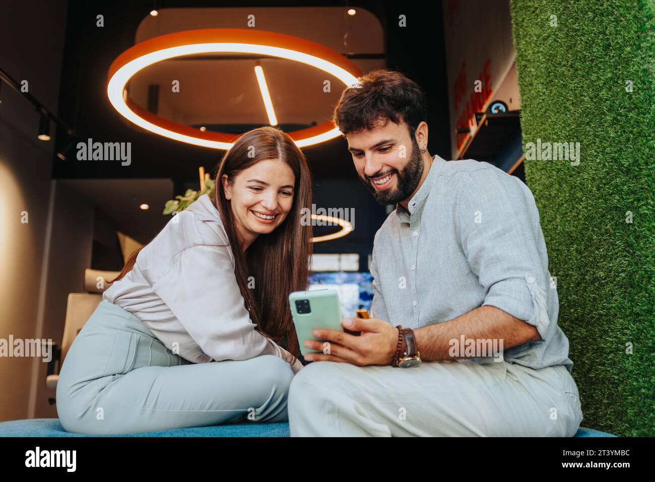 Confident colleagues collaborating in a modern workplace Stock Photo ...