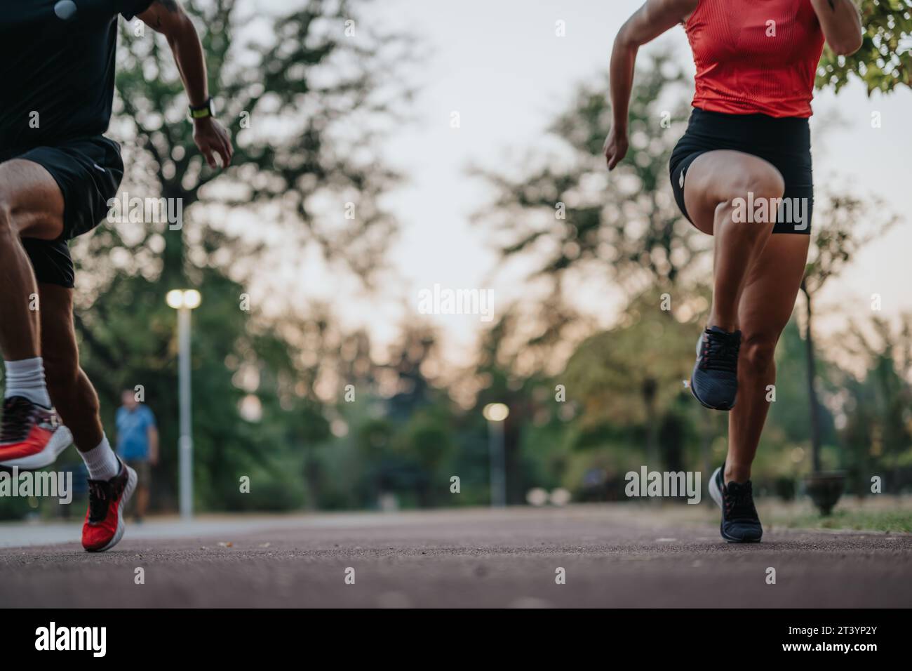 Active couple motivates each other while running in a park Stock Photo ...